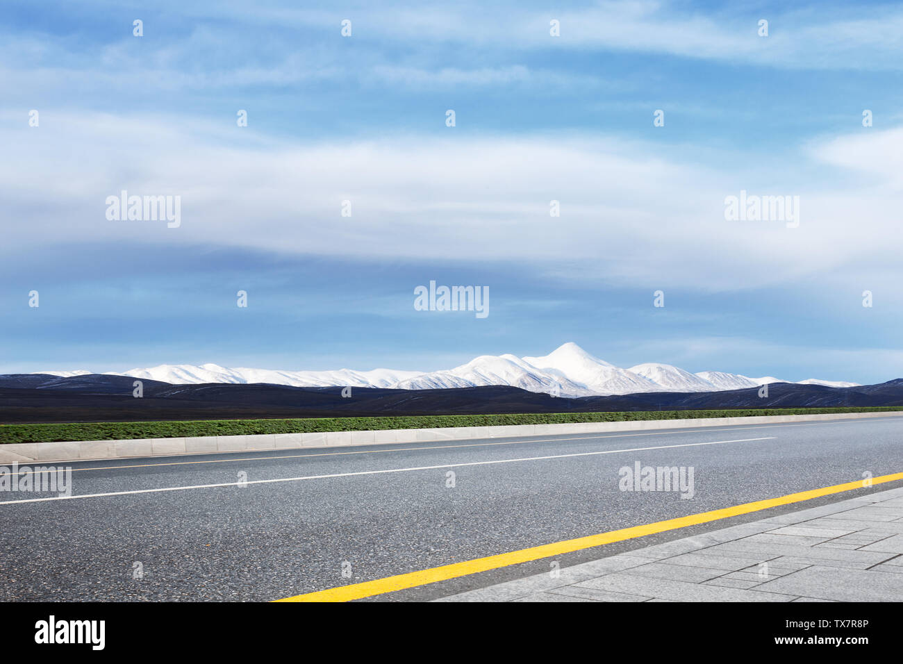 Empty asphalt road with snow mountains Stock Photo - Alamy