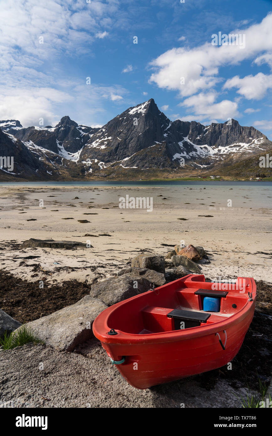 Red rowing boat on the sandy shore of a fjord, Lofoten Islands, Norway ...