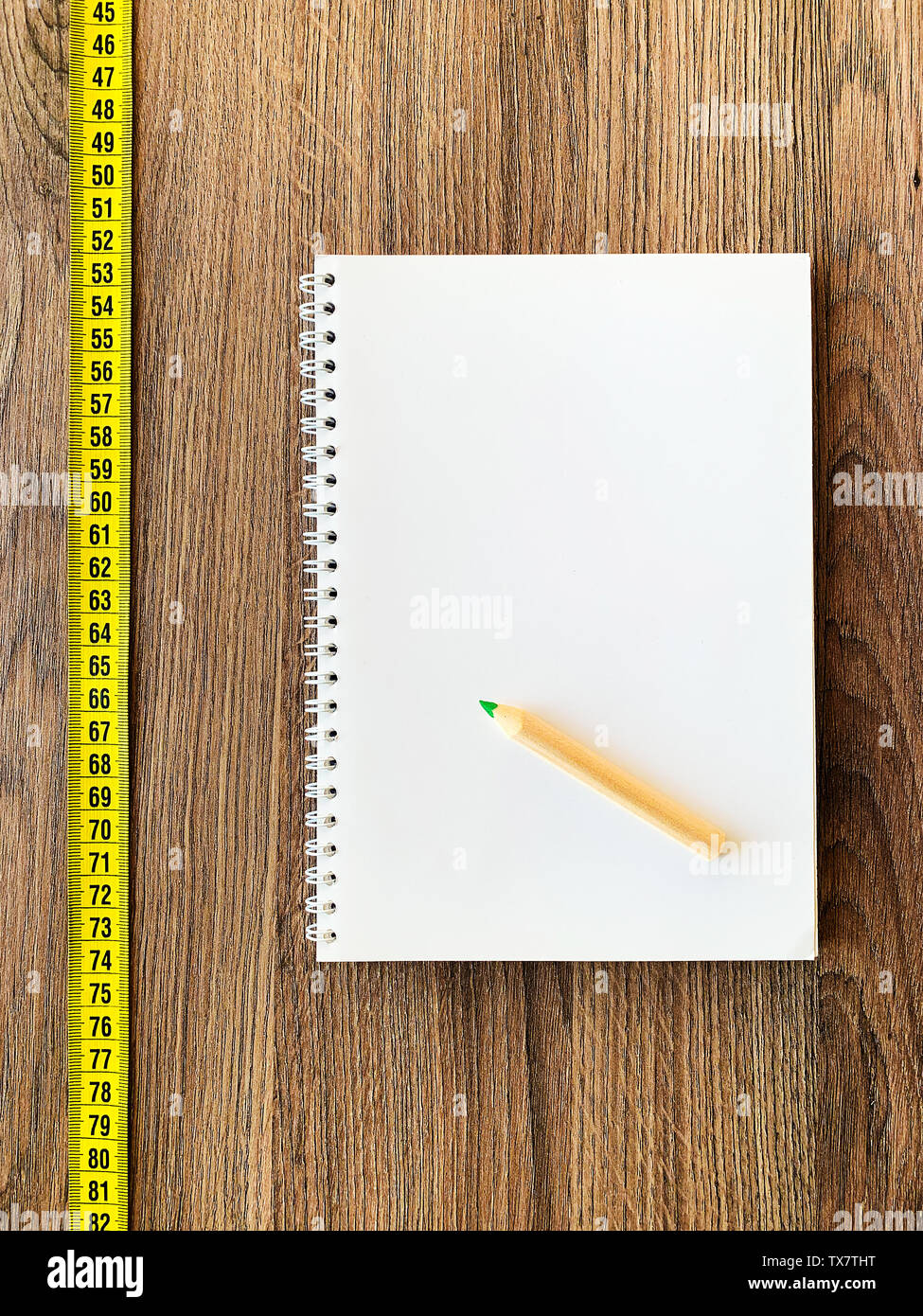 Diet concept. Measuring tape on wooden background with book diary ...