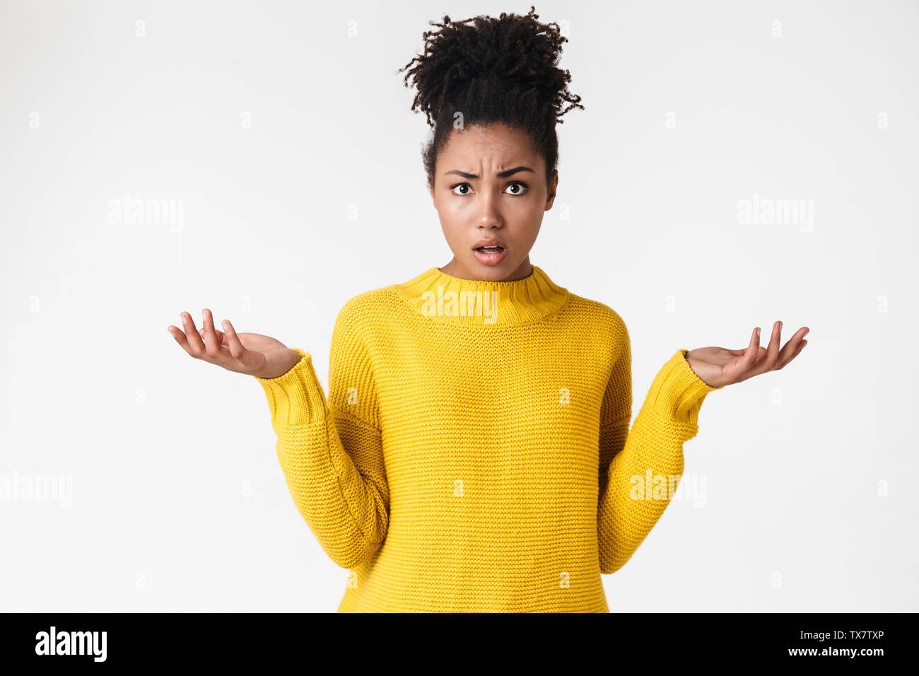 Photo of a beautiful young african confused woman posing isolated over ...