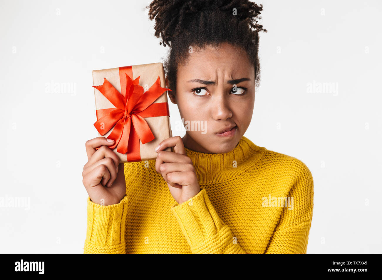 Image of a beautiful young african thinking woman posing isolated over ...