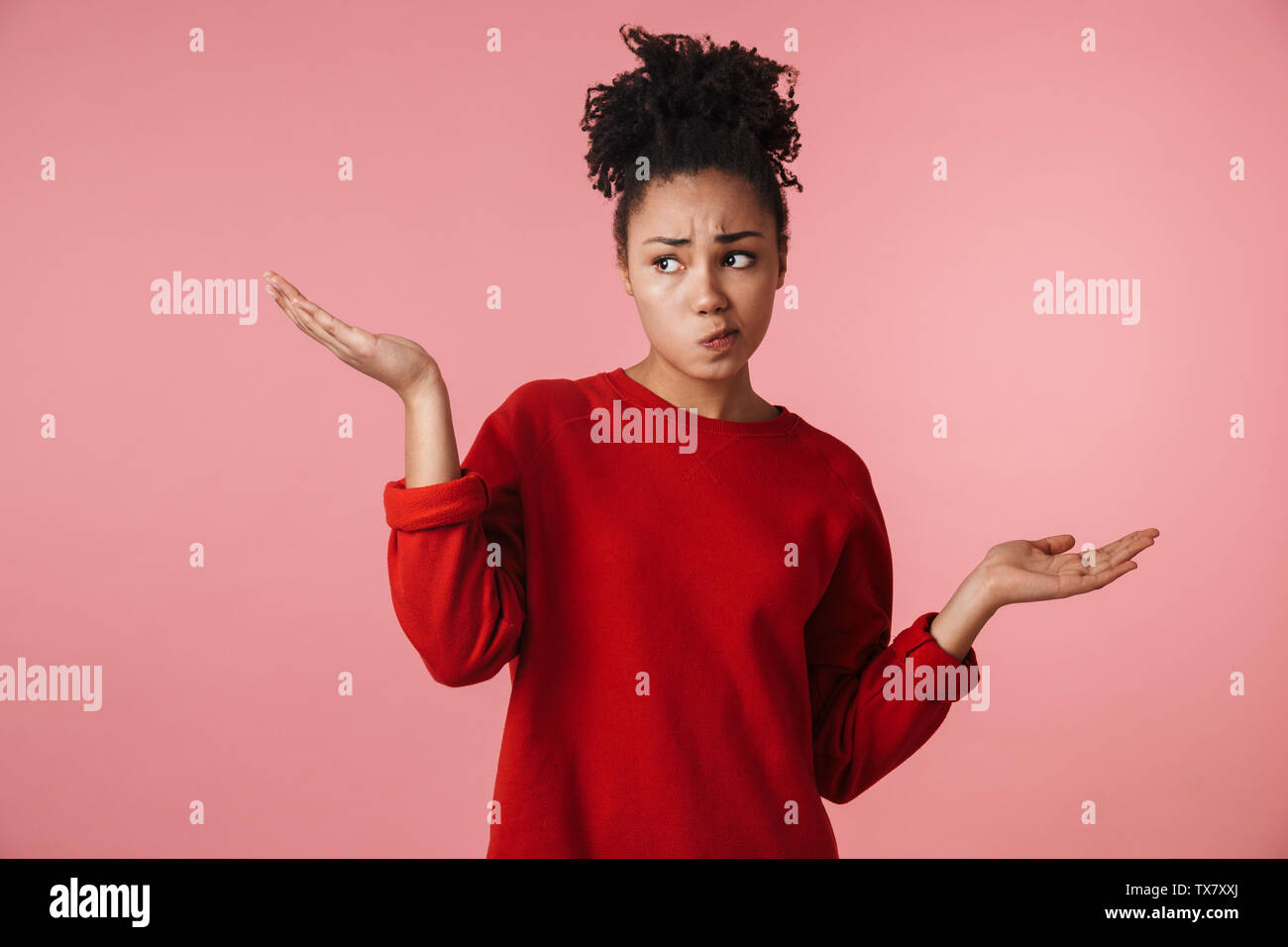Image of a beautiful young confused african woman posing isolated over ...