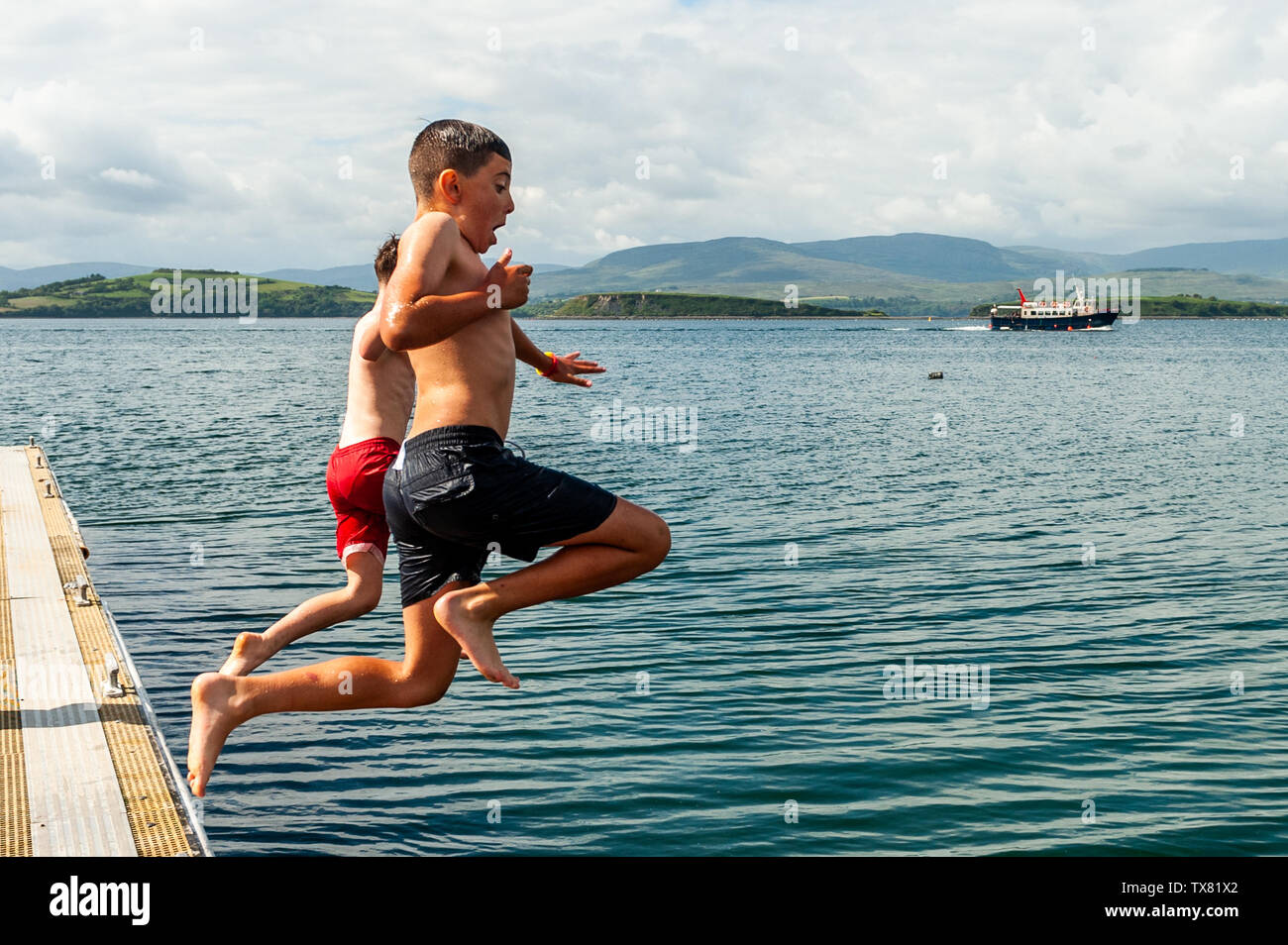 Boys jumping off pier hi-res stock photography and images - Alamy