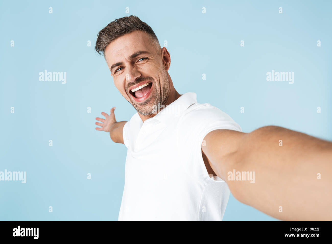 Image of a handsome excited emotional adult man posing isolated over ...