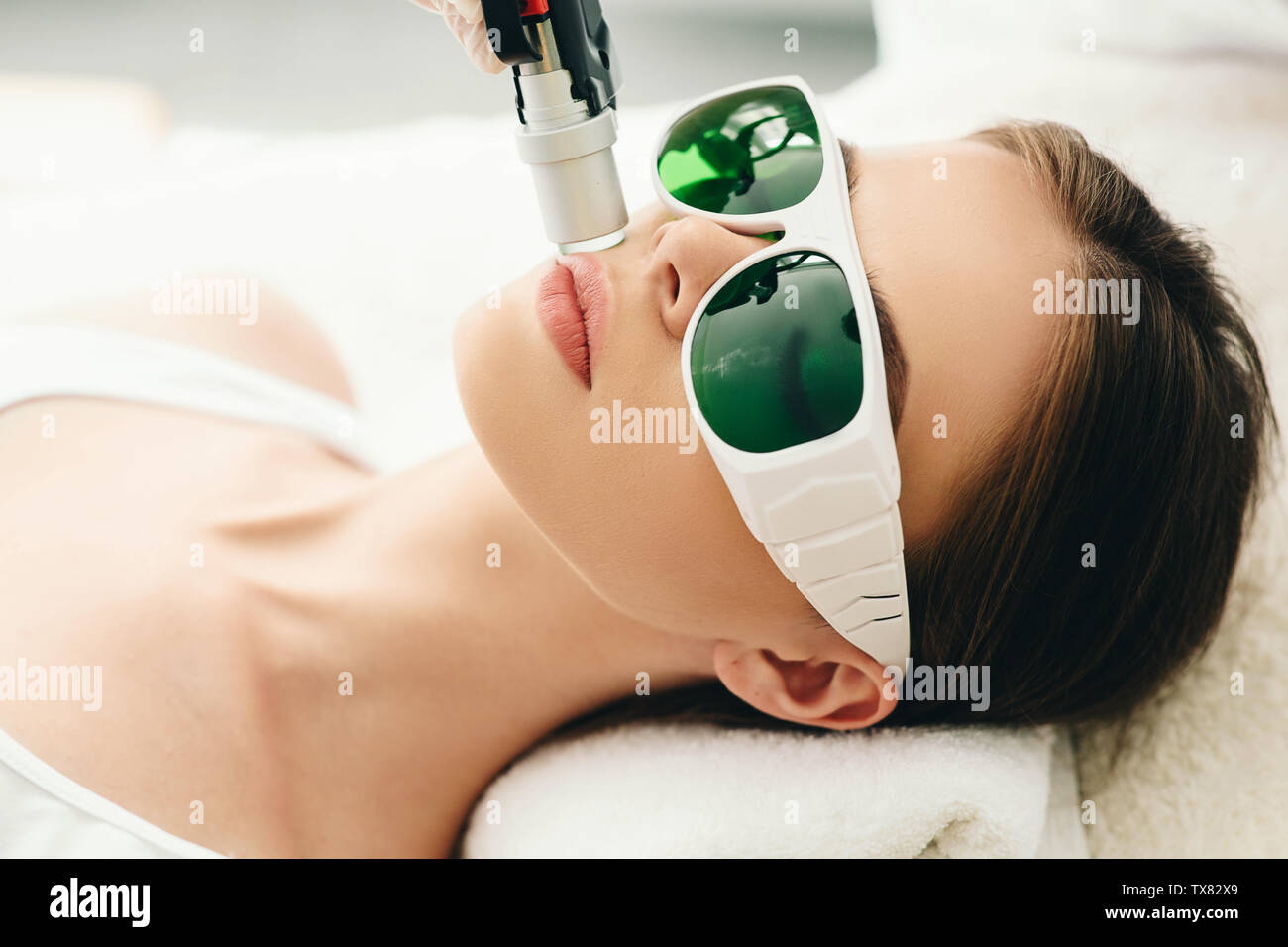 hair removal over the lip, female face during a laser hair removal ...