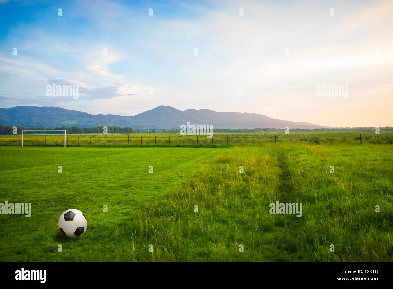 Improvissed football field in the nature with green grass and beautiful ...