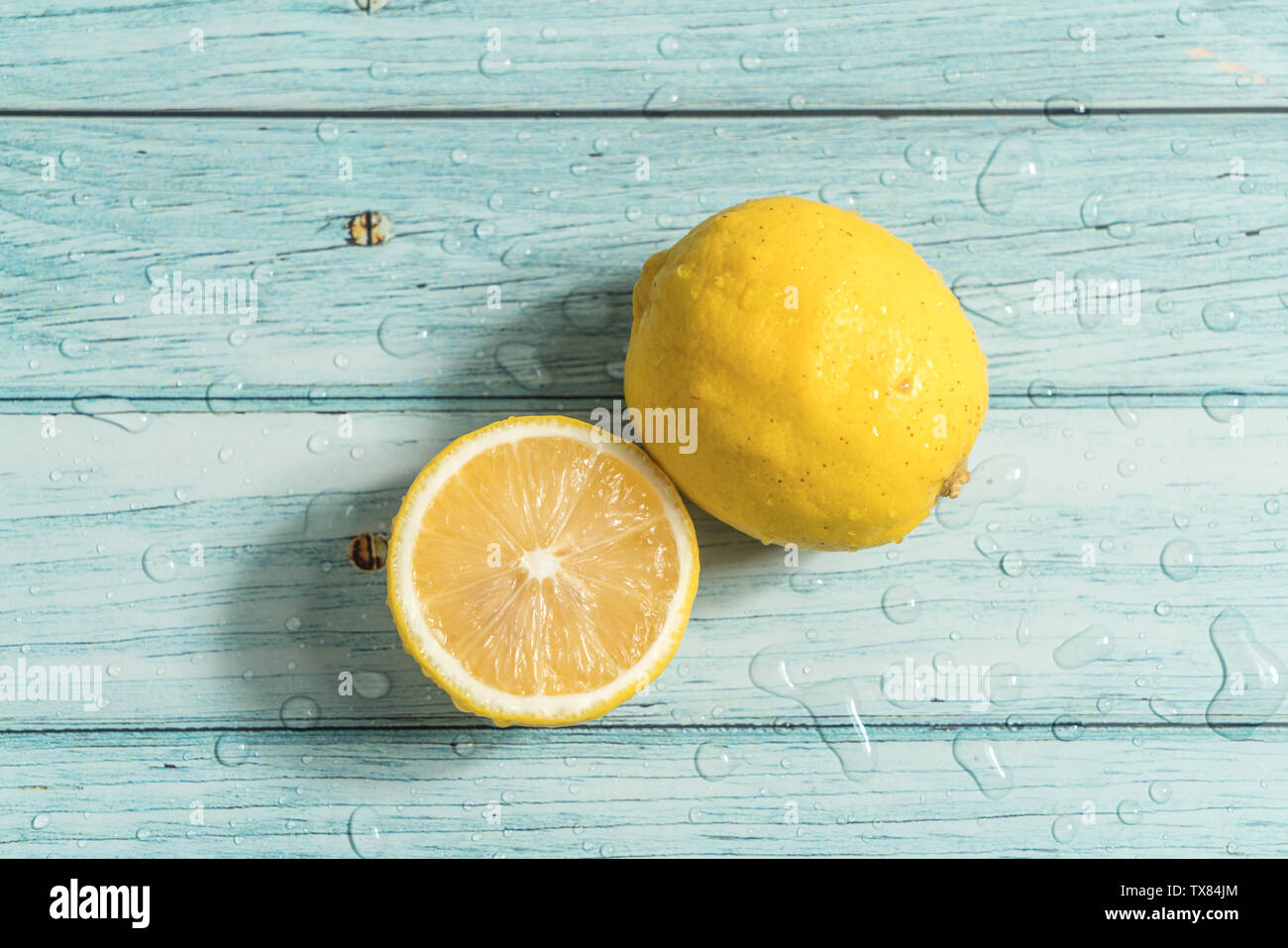 Lemon with teal wood pattern background Stock Photo - Alamy