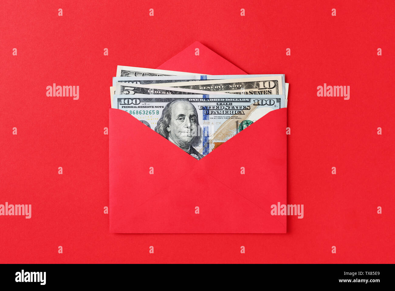American dollars in cash in envelope on red minimal background Money ...
