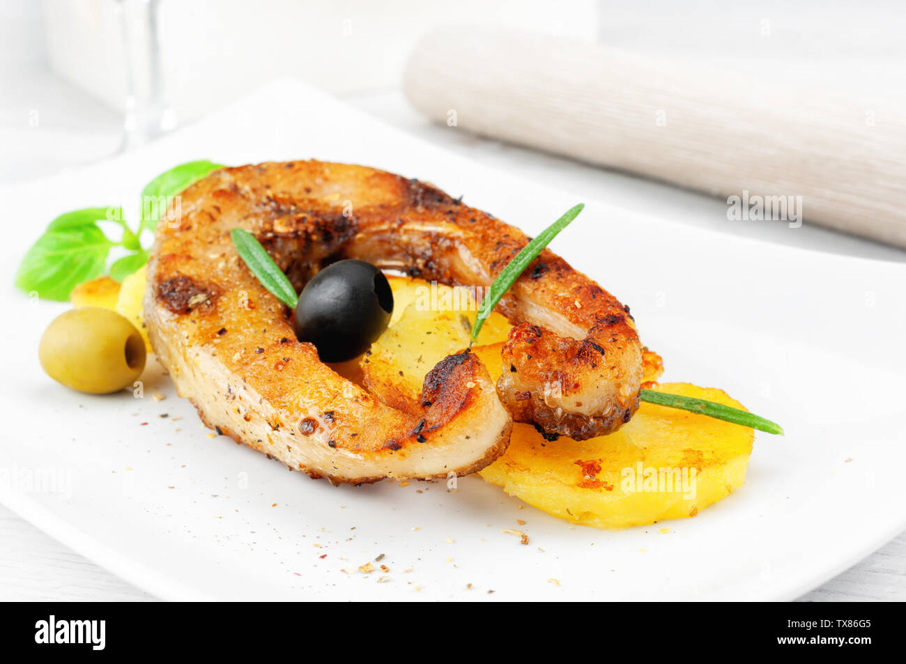 Roasted fish with potato Stock Photo - Alamy