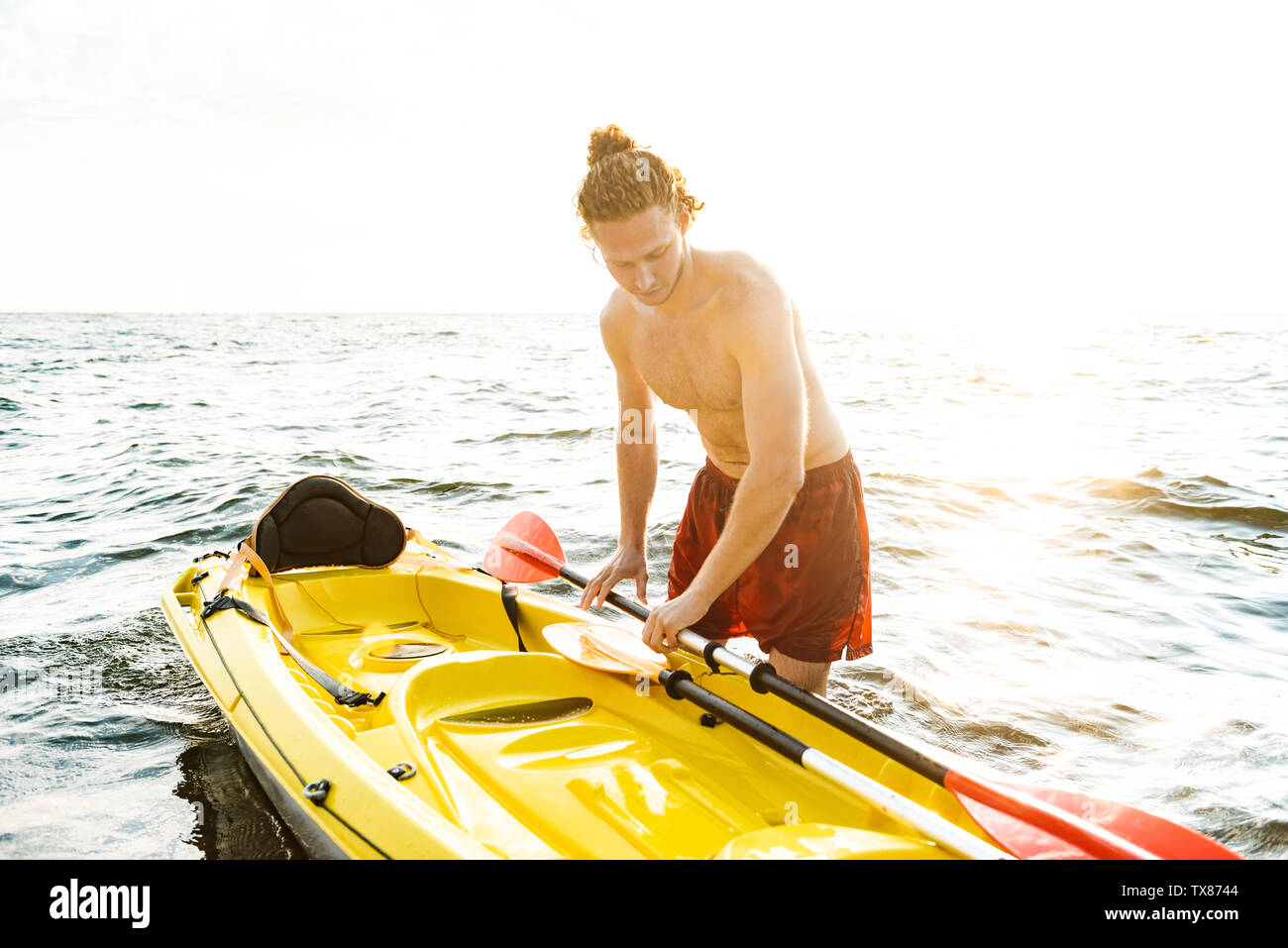 Healthy strong man kayaking on a sea Stock Photo - Alamy