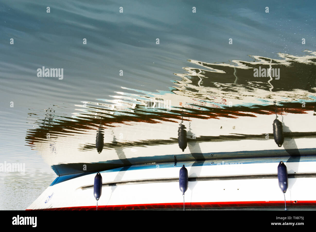 reflection on ripples on water of motor cruiser, boat, holiday boat ...