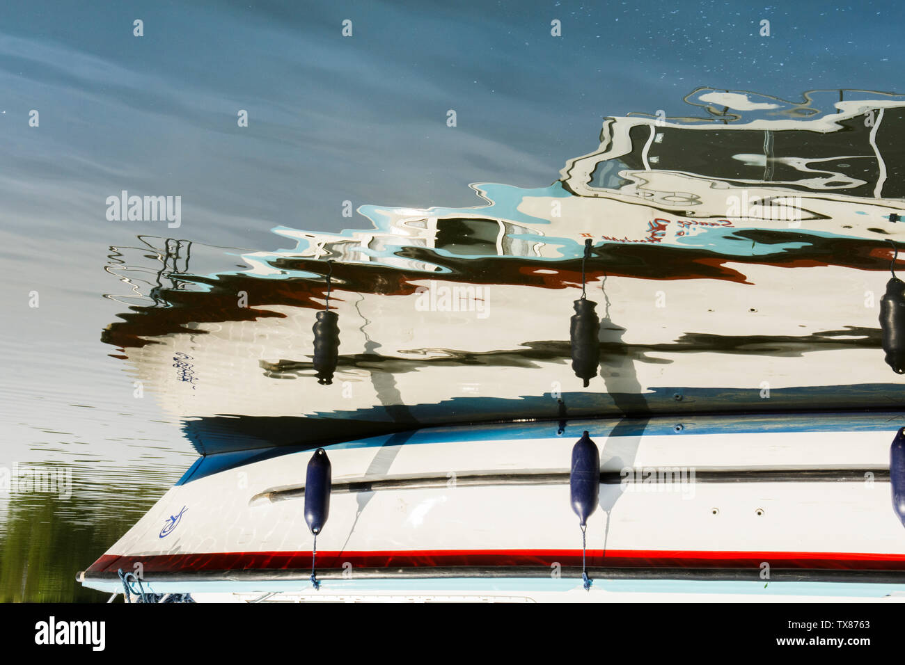 reflection on ripples on water of motor cruiser, boat, holiday boat ...