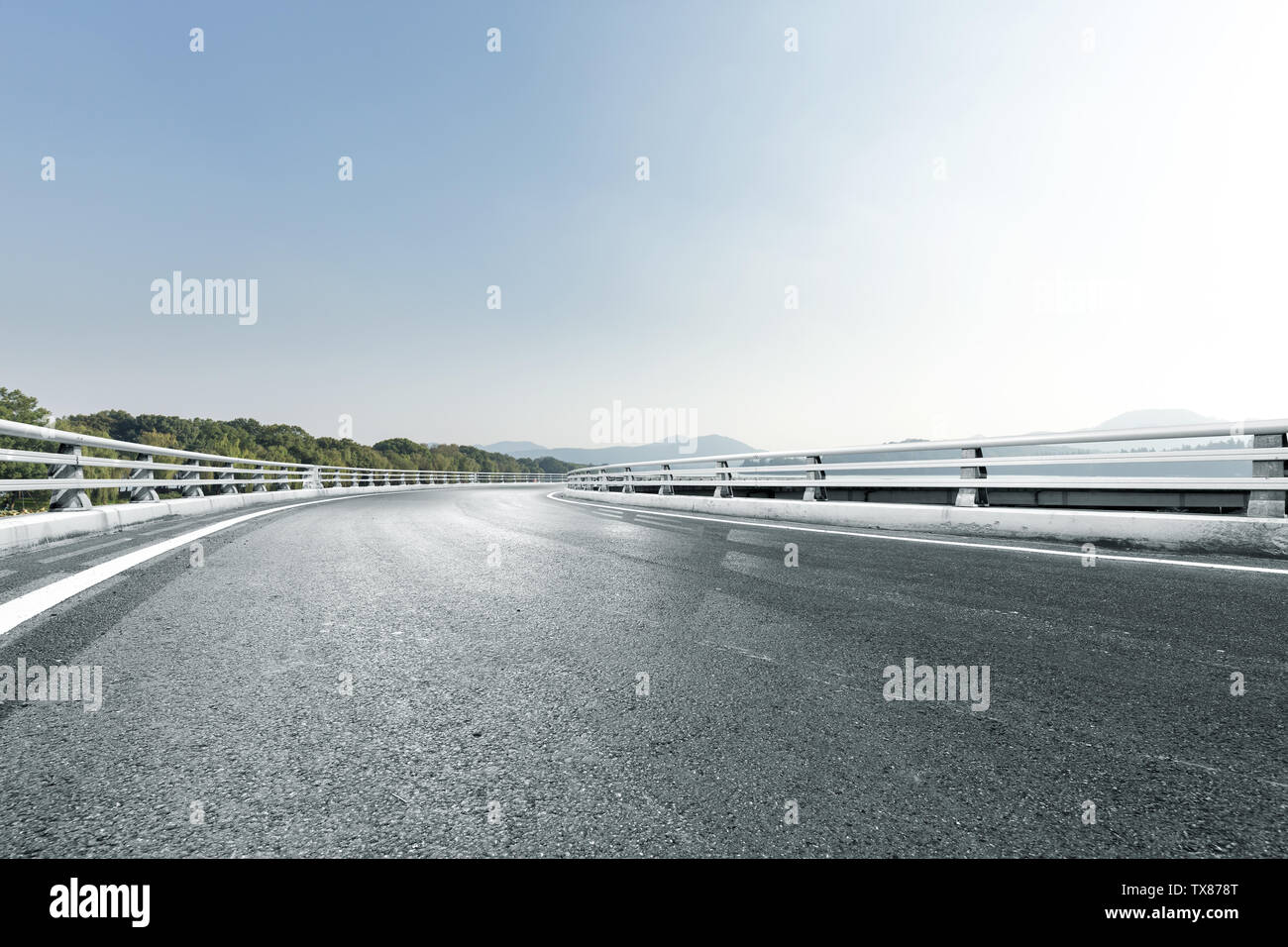 Empty asphalt road with beautiful lake Stock Photo - Alamy