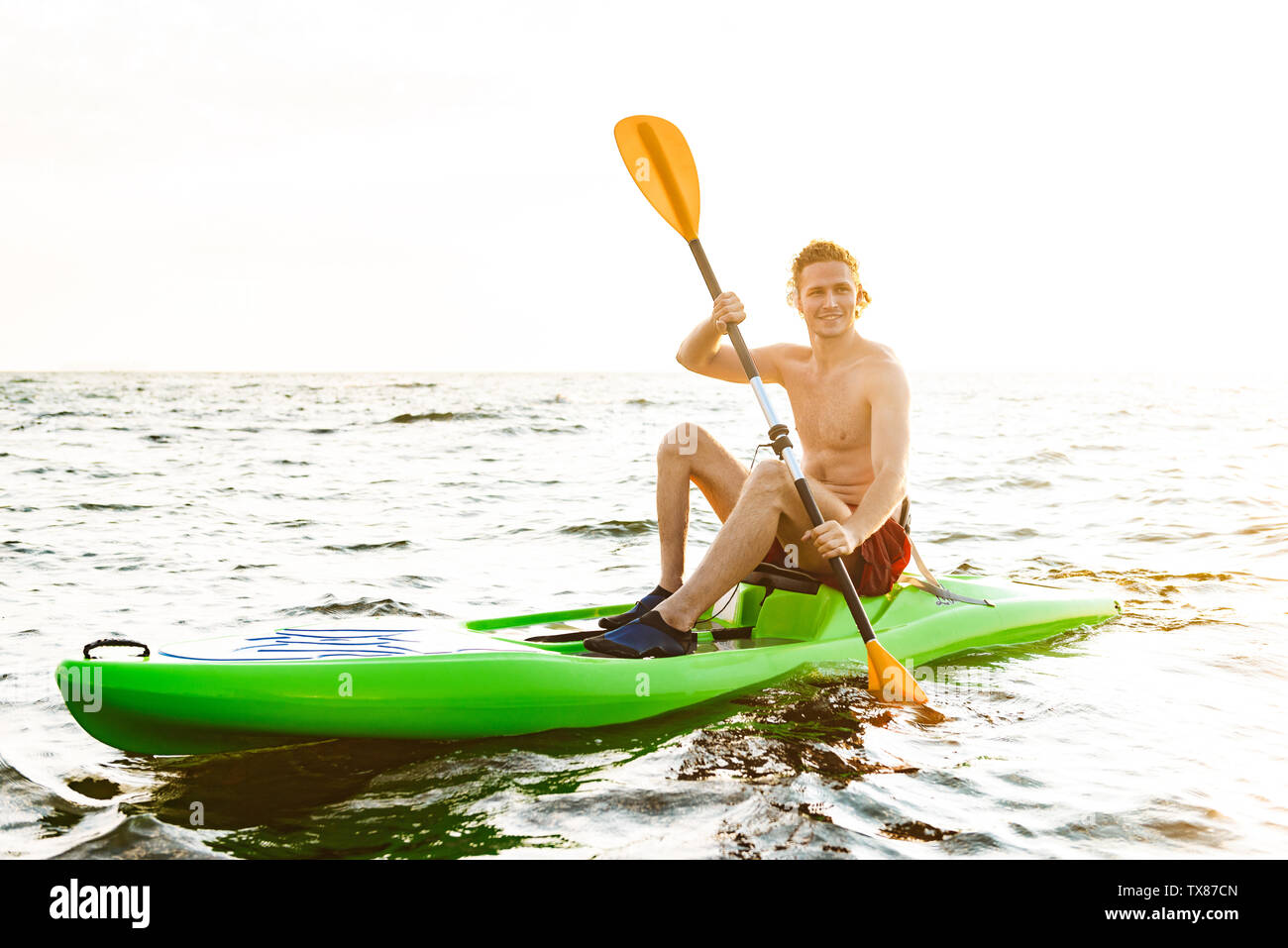 Healthy strong man kayaking on a sea Stock Photo - Alamy