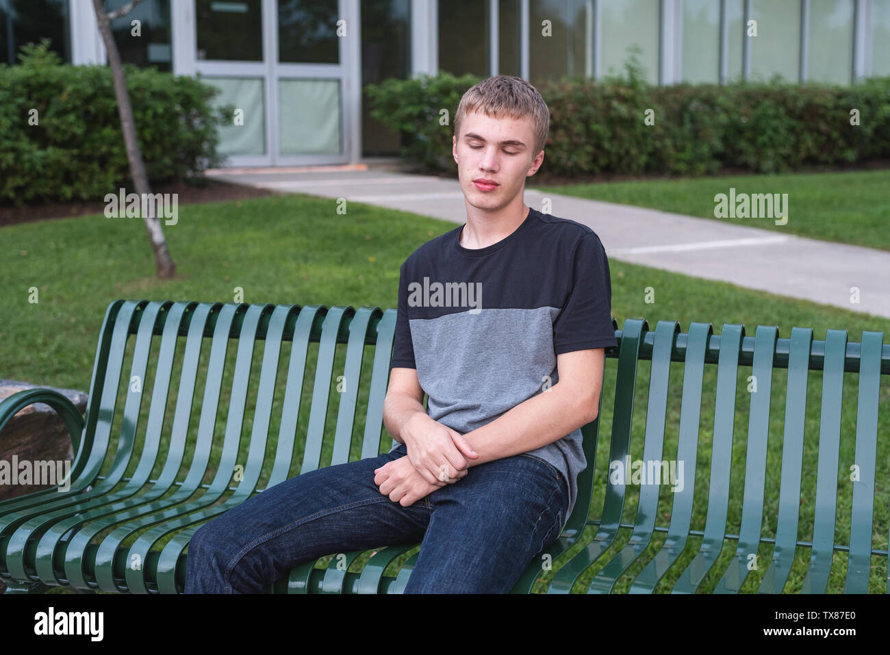Sad student sitting on bench hi-res stock photography and images - Alamy
