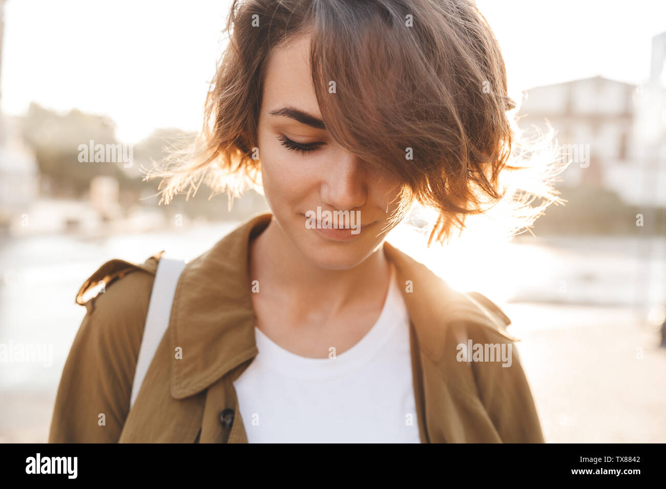 Image of a cute young amazing woman walking outdoors in park in ...