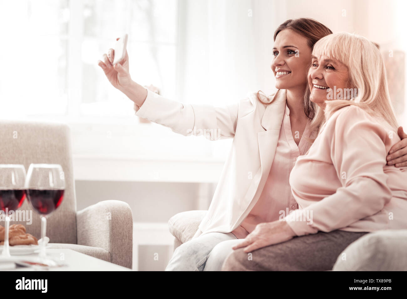 Two positive ladies in pink feeling wonderful together Stock Photo - Alamy