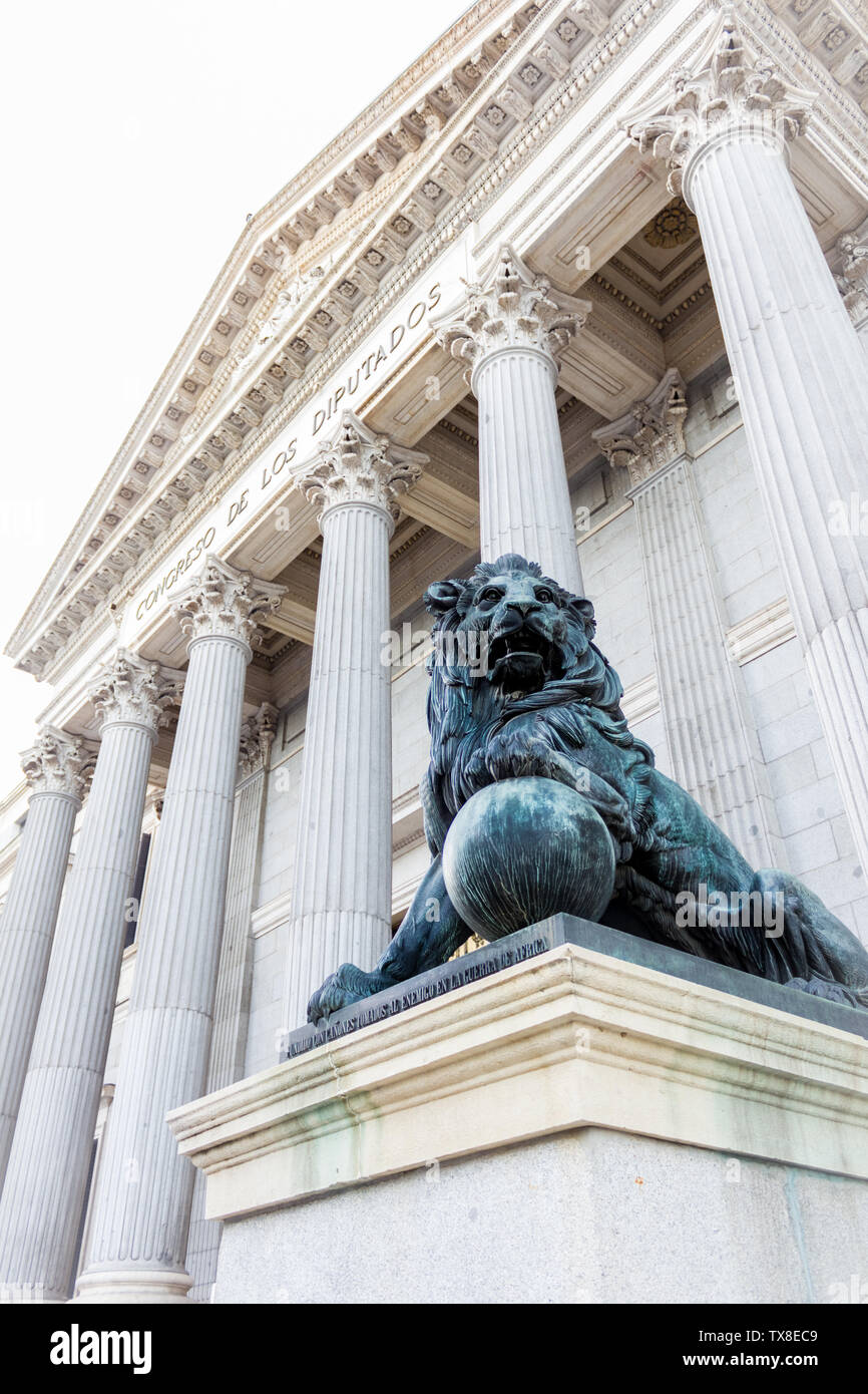 Lion statue at the main entrance of the Spanish Congress on a white ...