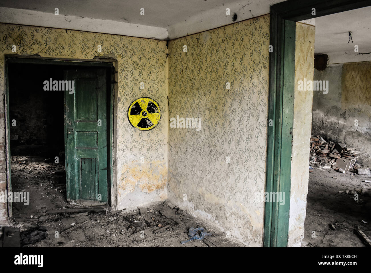 Radioactive warning sign on the grunge dirty wall in abandoned building ...