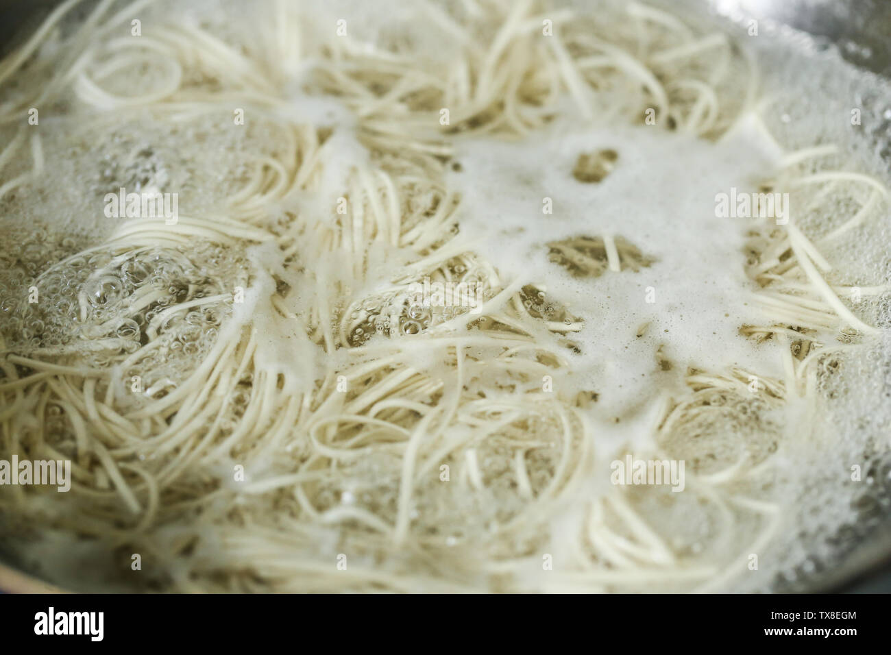 Noodles in boiling water Stock Photo - Alamy