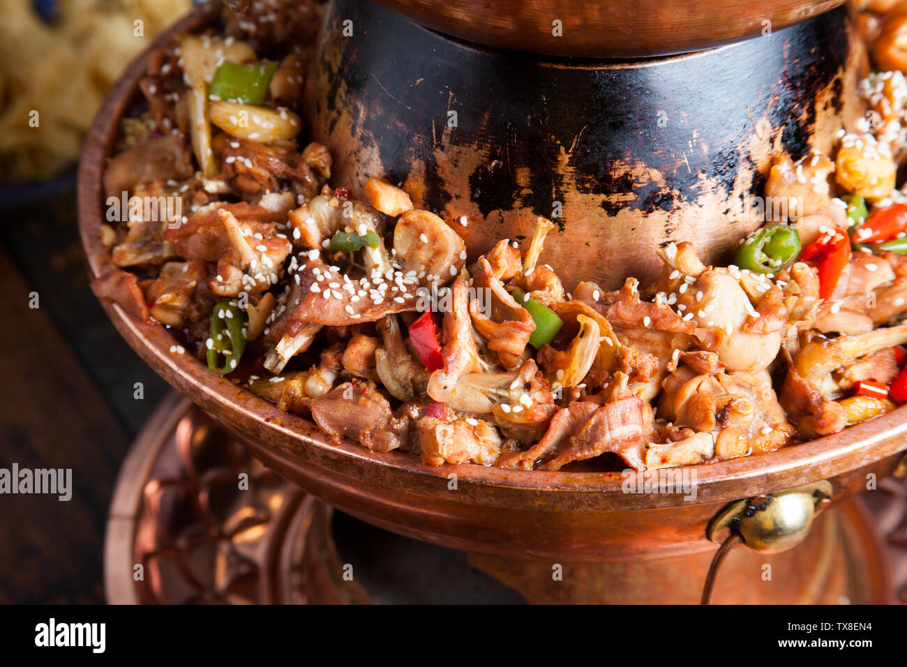 Charcoal fire frog pot field chicken meal Stock Photo - Alamy