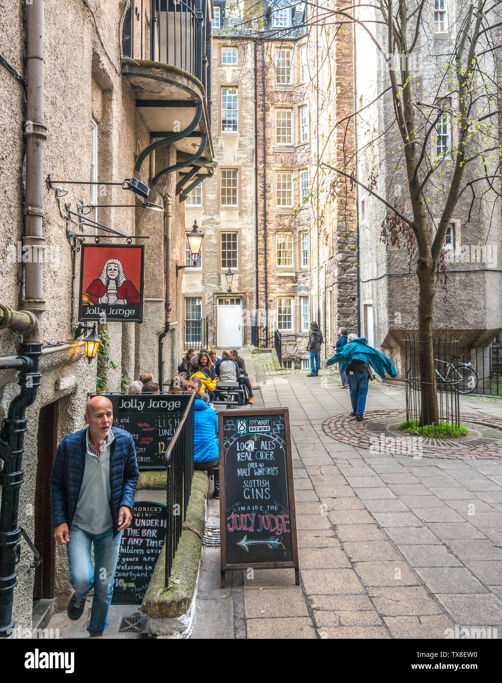 The Jolly Judge pub, with people sitting outside at tables, in a ...