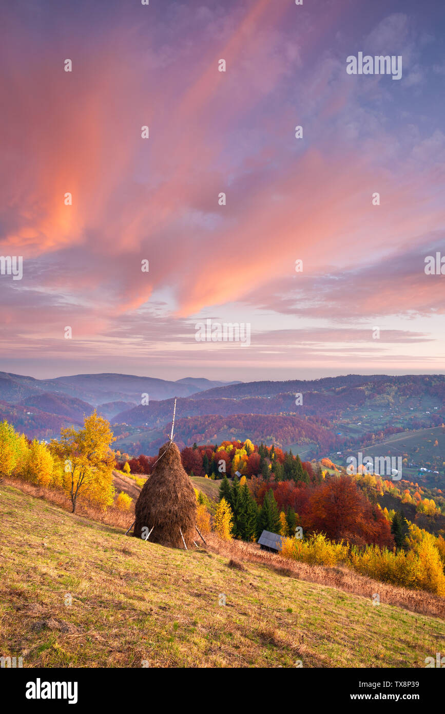 Autumn landscape with a beautiful sky and clouds. Stack dry hay in the ...