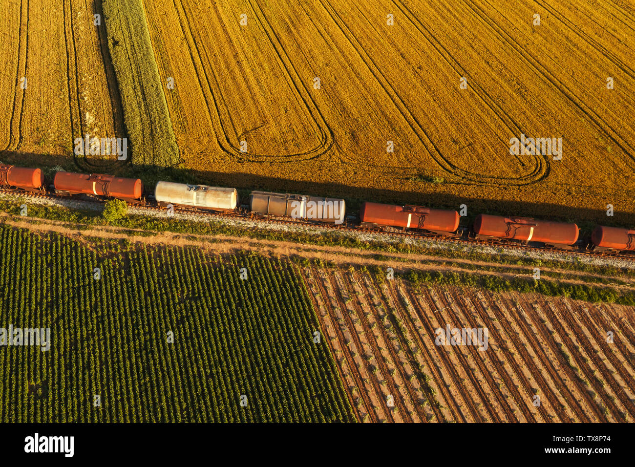 Rail freight transport, aerial view of train passing on railway through ... Rail freight transport, aerial view of train passing on railway through ...