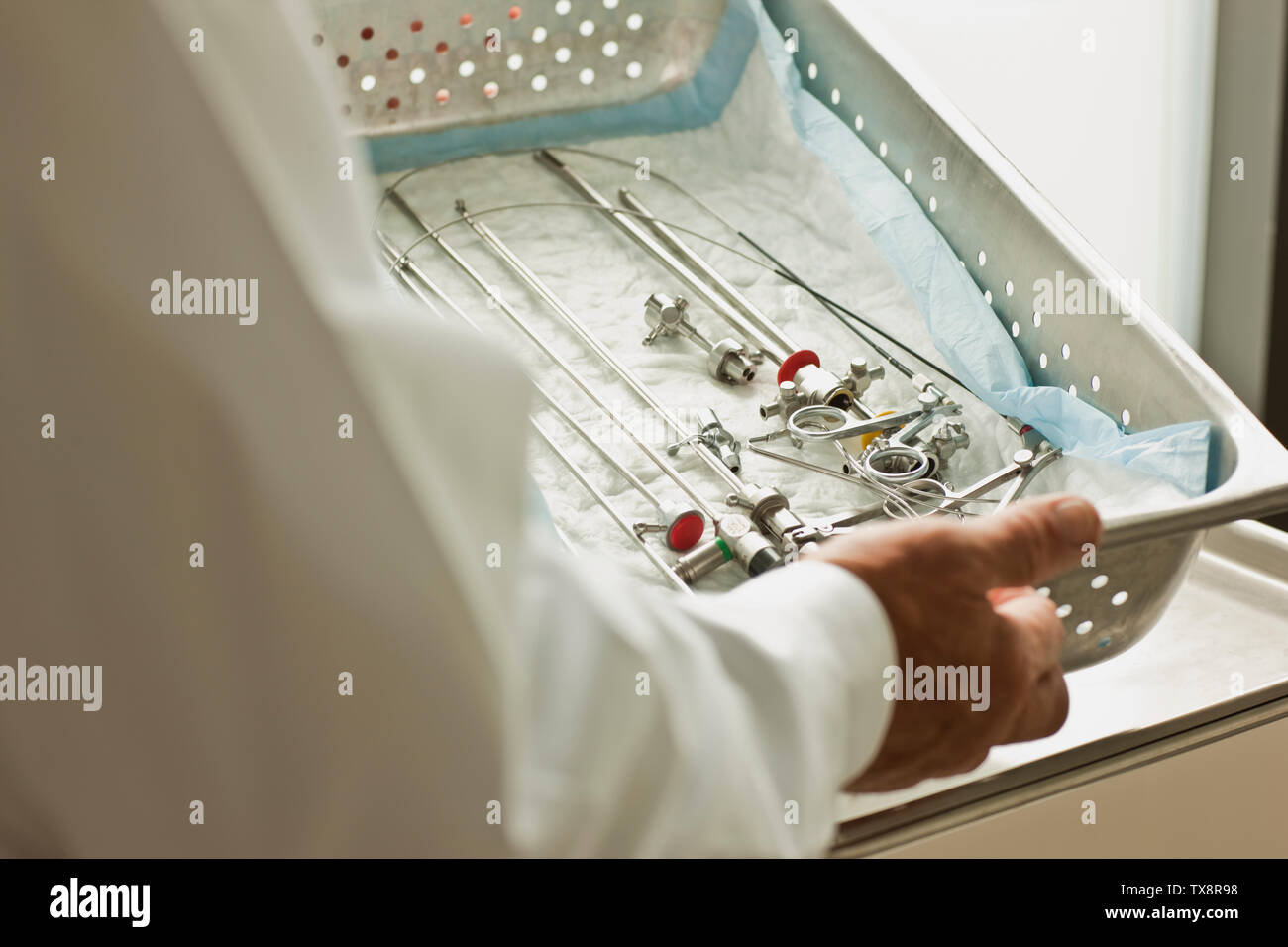 Doctor holding a tray of medical instruments Stock Photo - Alamy