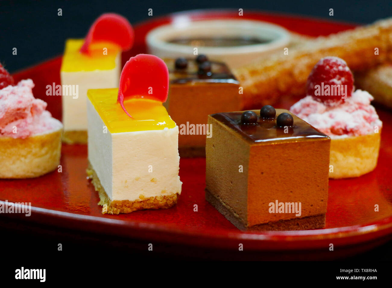 assorted french pastries in a red color plate Stock Photo - Alamy