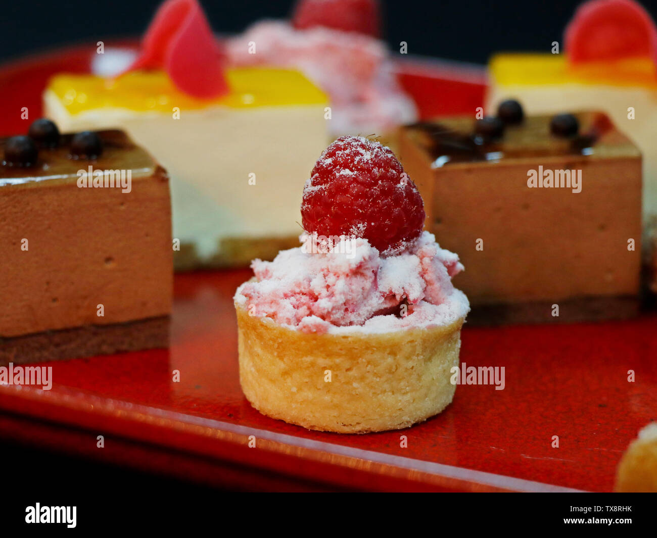 assorted french pastries in a red color plate Stock Photo - Alamy
