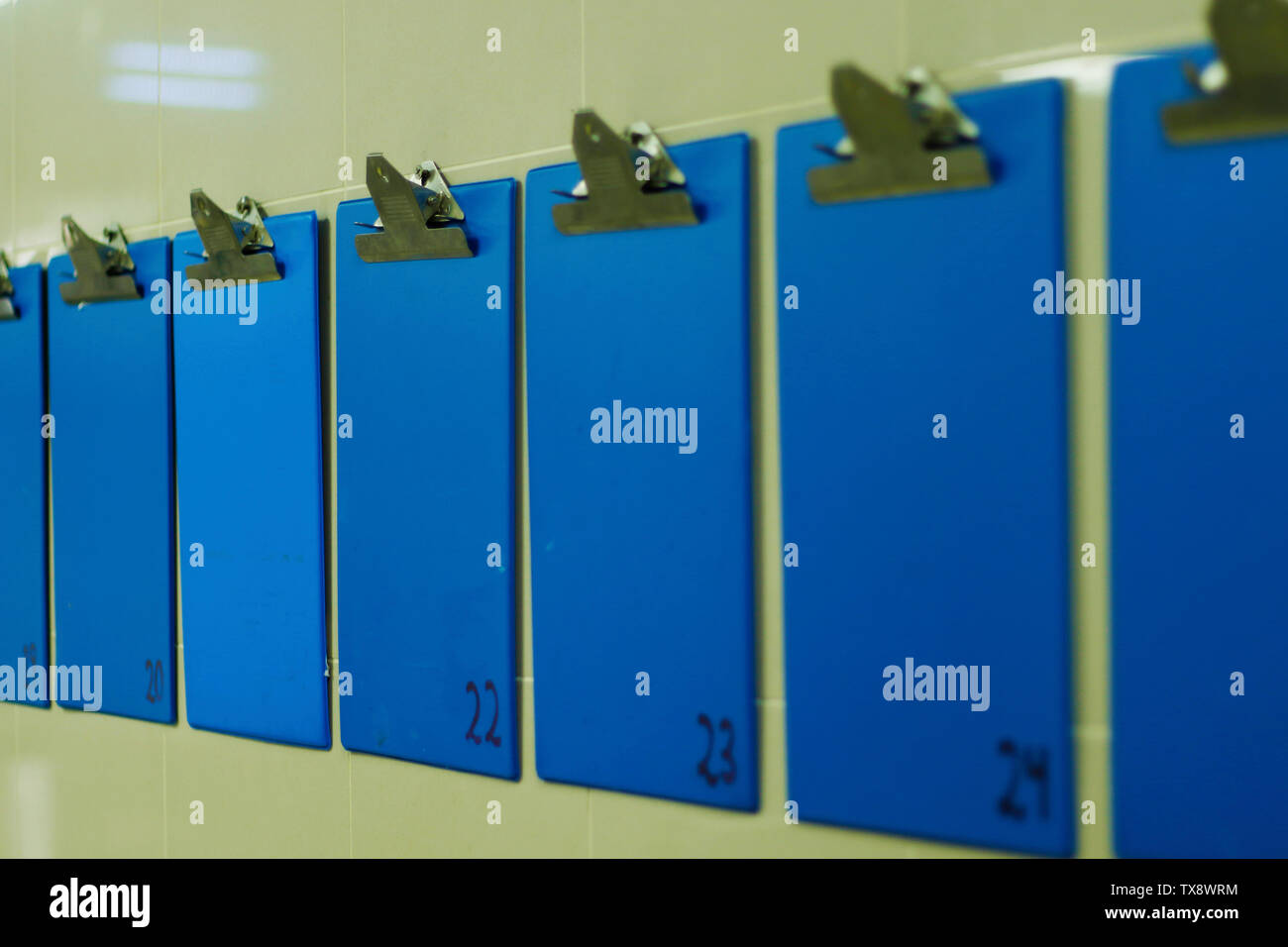 blue color information clip board on wall Stock Photo - Alamy