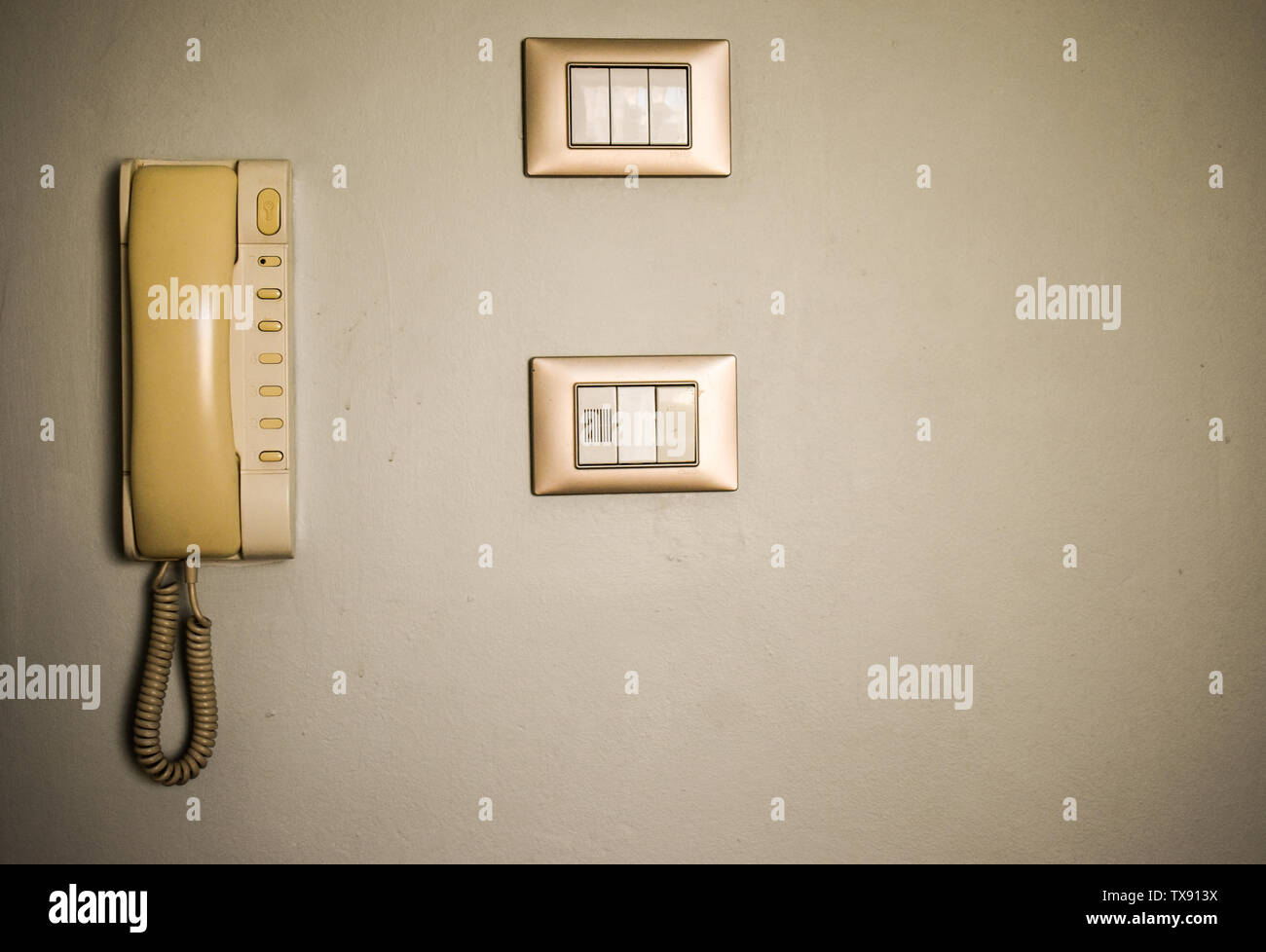 Vintage hotel room facilities. Old switches and antique phone on the ...