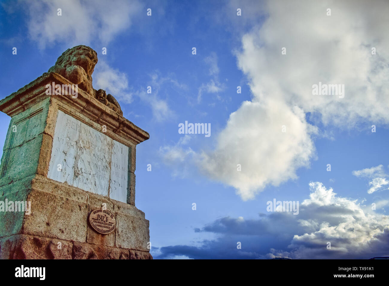 Old plinth road sign with a blue sky and clouds Stock Photo - Alamy