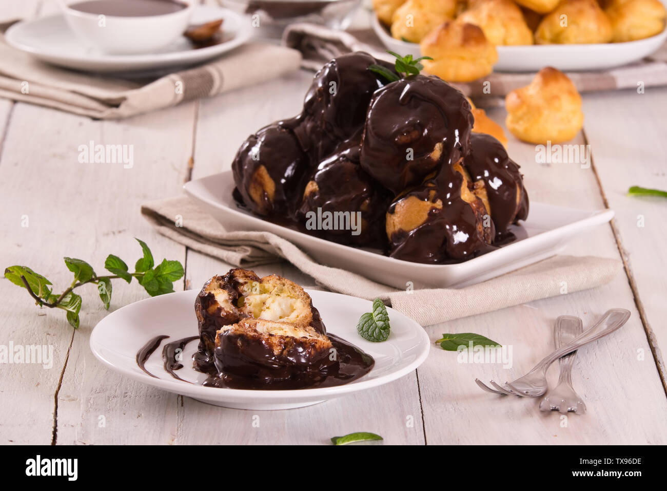 Chocolate profiteroles with chantilly cream hi-res stock photography ...