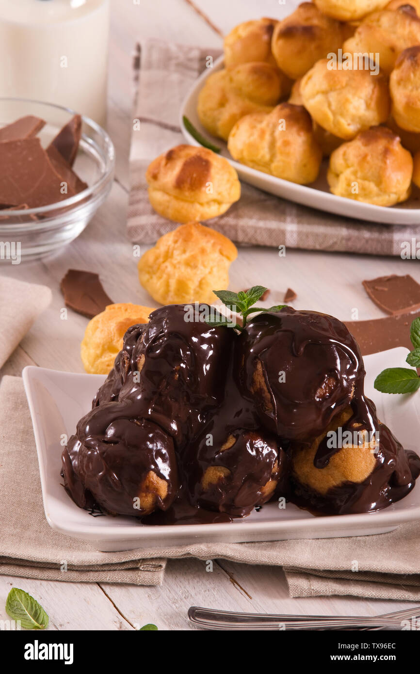 Chocolate profiteroles with chantilly cream hi-res stock photography ...