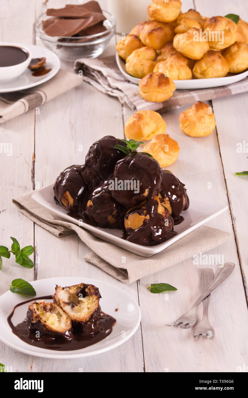 Chocolate profiteroles with chantilly cream hi-res stock photography ...