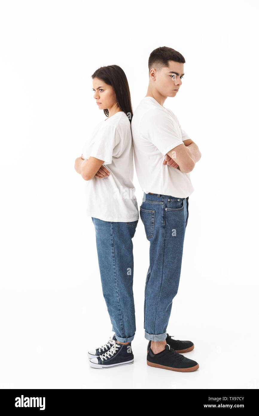 Full length portrait of a young angry attractive couple standing ...