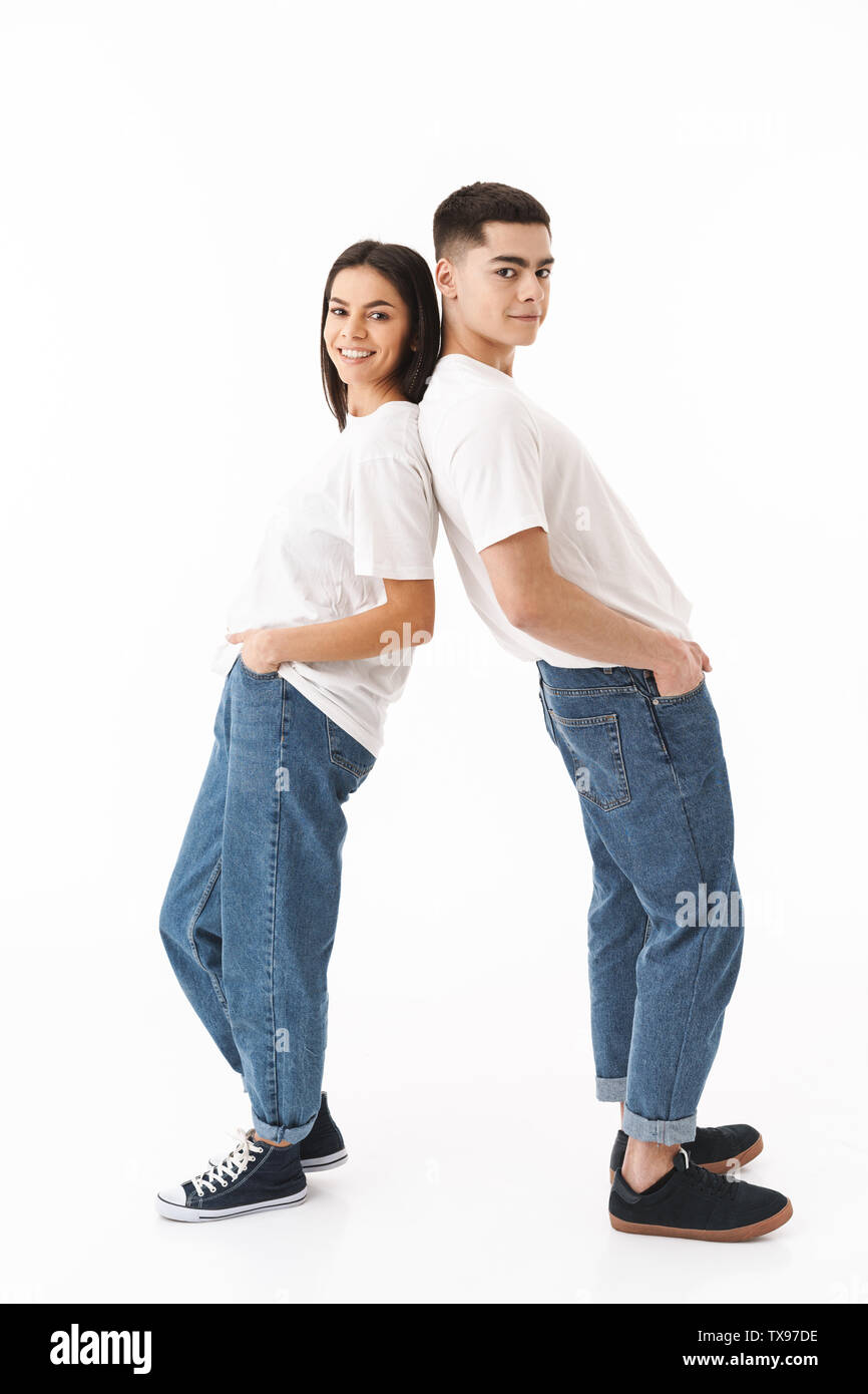 Full length portrait of a young attractive couple standing isolated ...