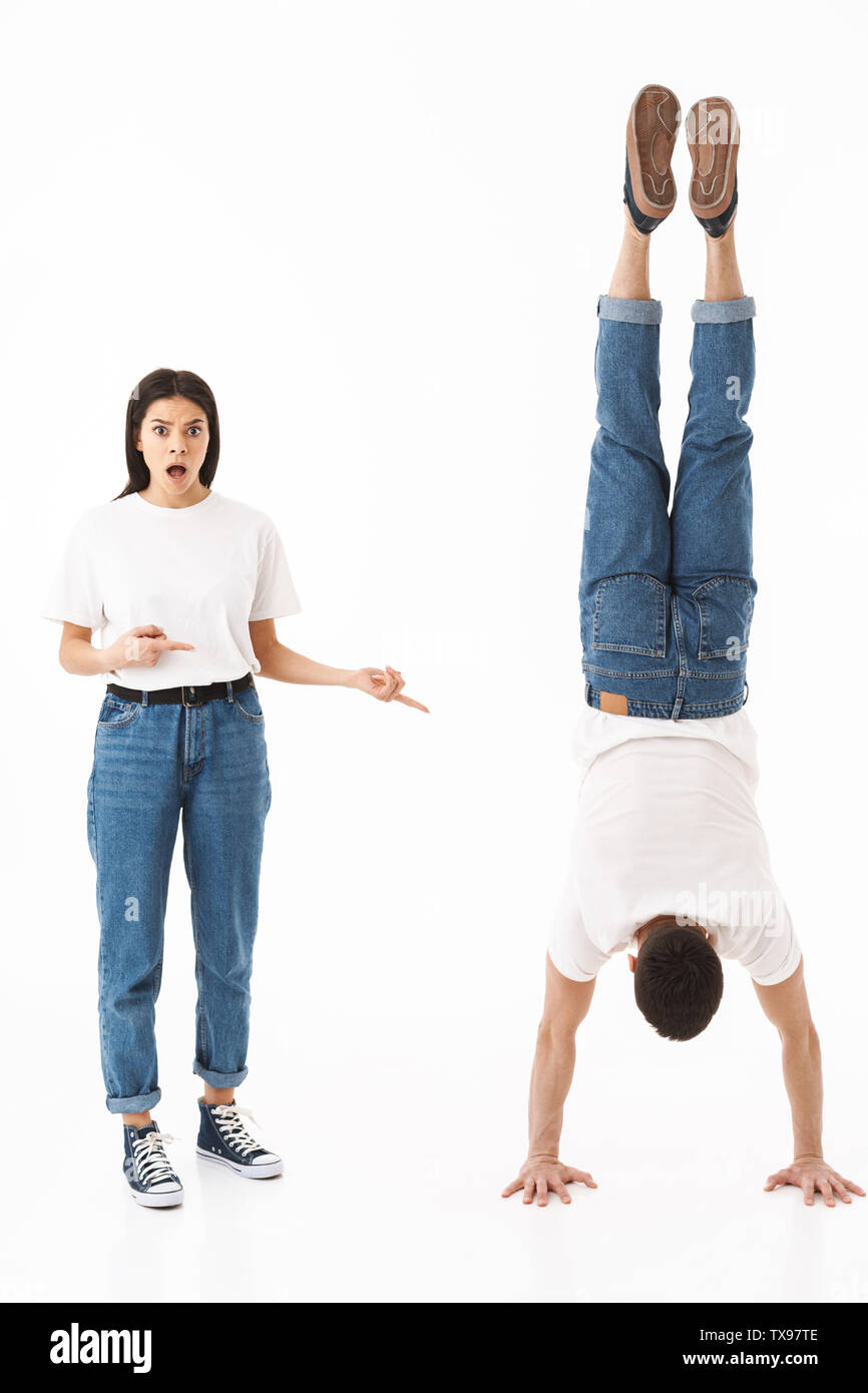 Full length portrait of a young attractive couple standing isolated ...