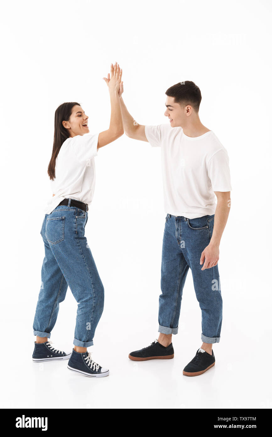 Full length portrait of a young attractive couple standing isolated ...