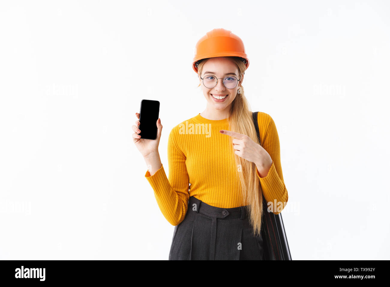 Attractive young woman architect standing isolated over white ...