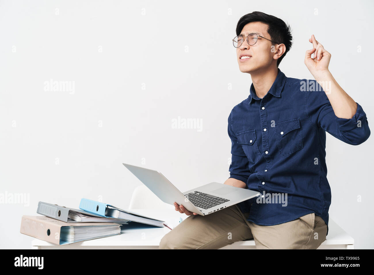 Photo of confident asian man 30s wearing eyeglasses crossing fingers ...