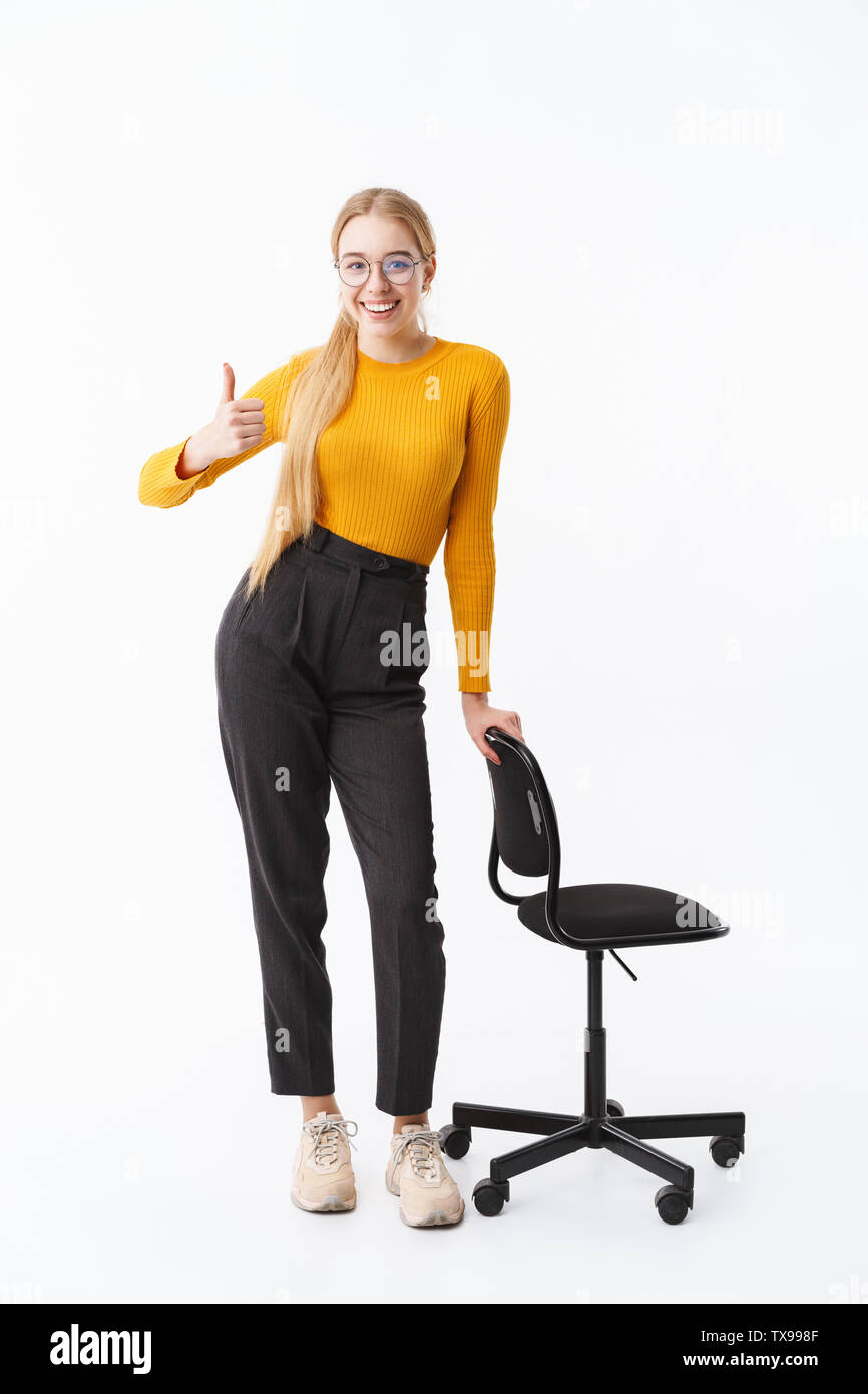 Full length of an attractive young woman standing isolated over white ...