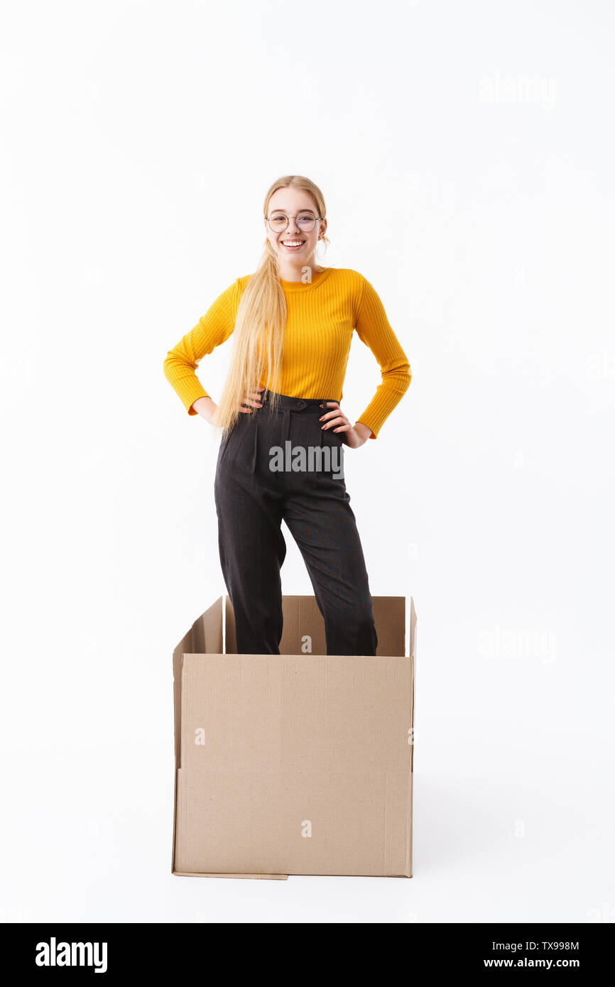 Attractive young woman standing inside the box isolated over white ...