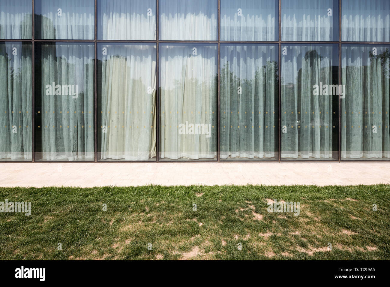 modern office glass wall and grass field Stock Photo - Alamy