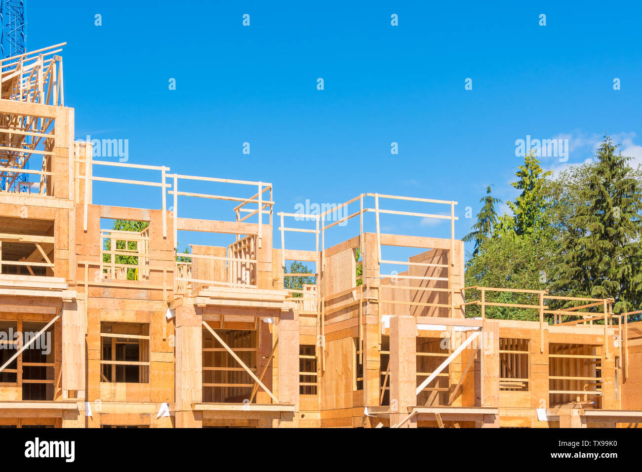 New condo building under construction on blue sky and trees background ...