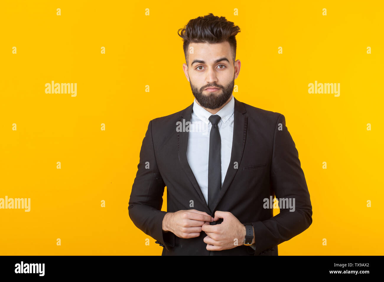 Charming young self-confident businessman wearing formal clothes posing ...