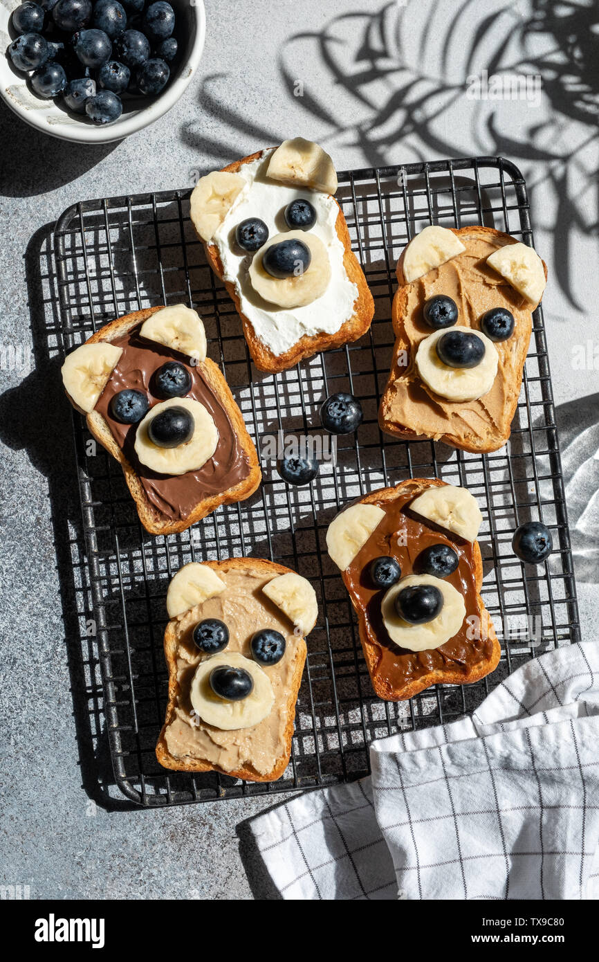 Funny children bear toasts with nuts butters Stock Photo - Alamy