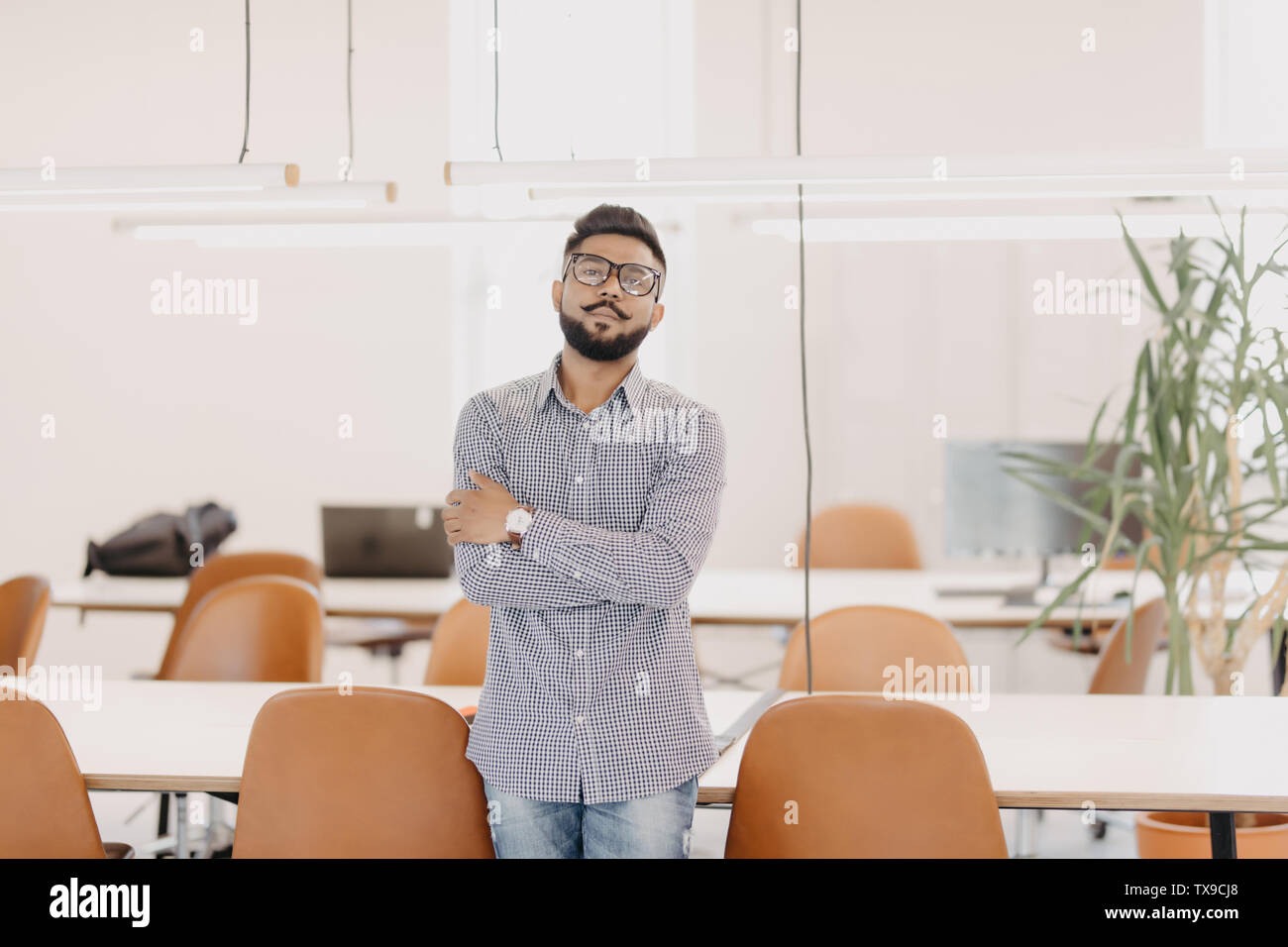 happy indian business man standing in office Stock Photo - Alamy